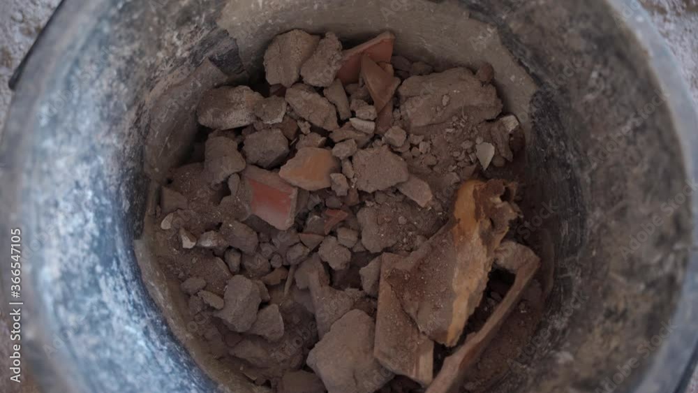 Stack of construction waste inside the dirty metal bucket, pieces of ...