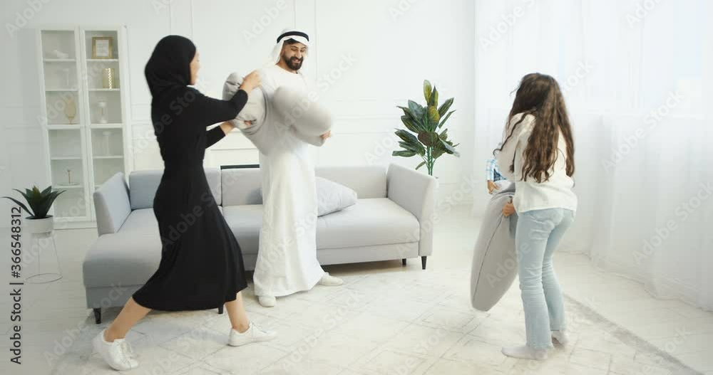 Arabian happpy cheerful family with kids playing and having fun at home ...
