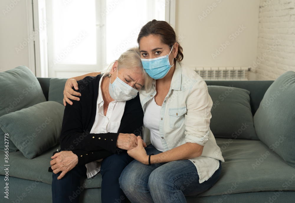 Mother and daughter crying at home in quarantine grieving loss of ...
