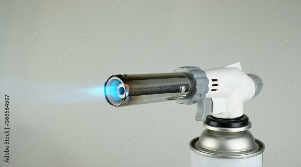 Flamethrower burner gas blow torch Ignition with blue fire flame at ...