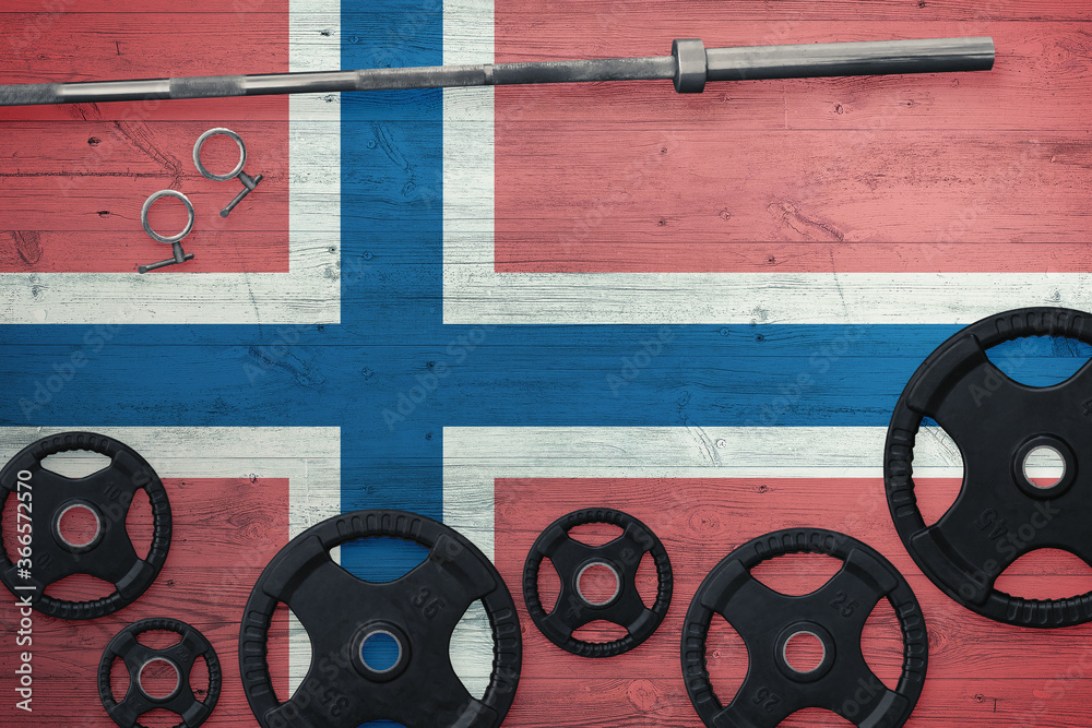 Norway gym concept. Top view of heavy weight plates with iron bar on ...