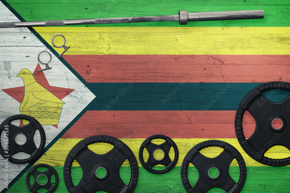 Zimbabwe gym concept. Top view of heavy weight plates with iron bar on ...