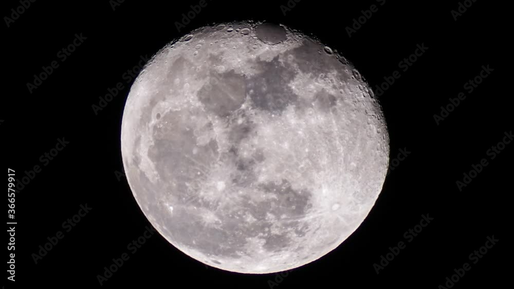 Full moon zoom in close up detail trough telescope rising time-lapse ...