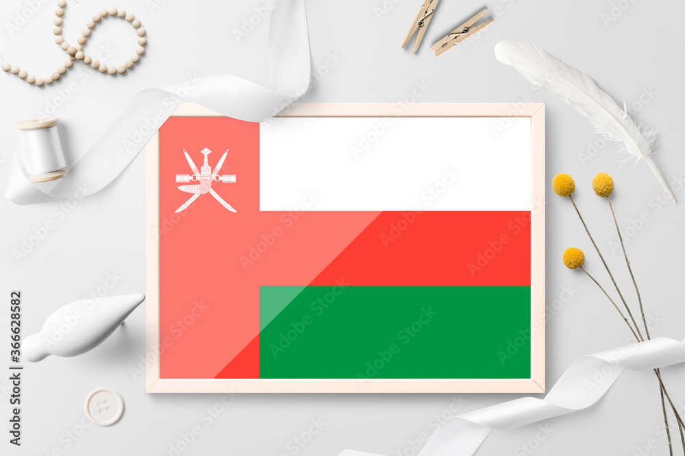 Oman flag in wooden frame on white creative background. White theme ...