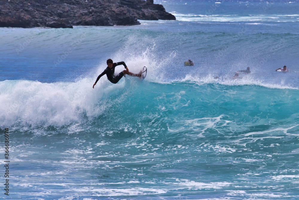 Poster High energy surfer on an action packed big wave on the island of ...