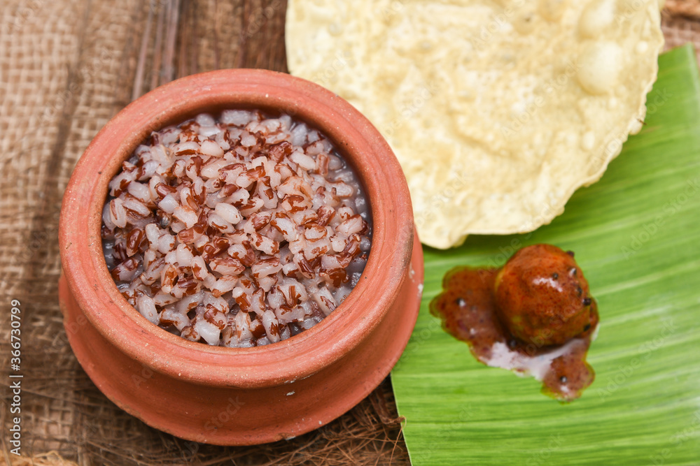 Rice porridge, Kanji, gruel in clay pot palm mat background Kerala ...