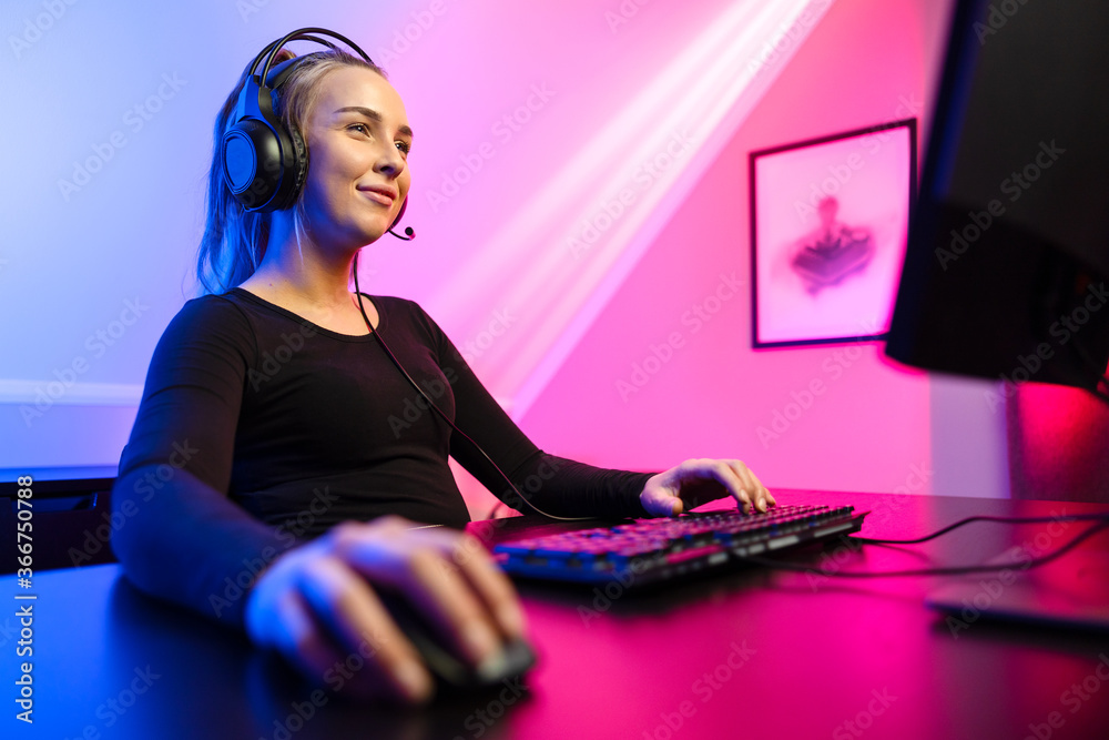 Happy and Beautiful Blonde Gamer Girl Playing Online Video Game on Her ...