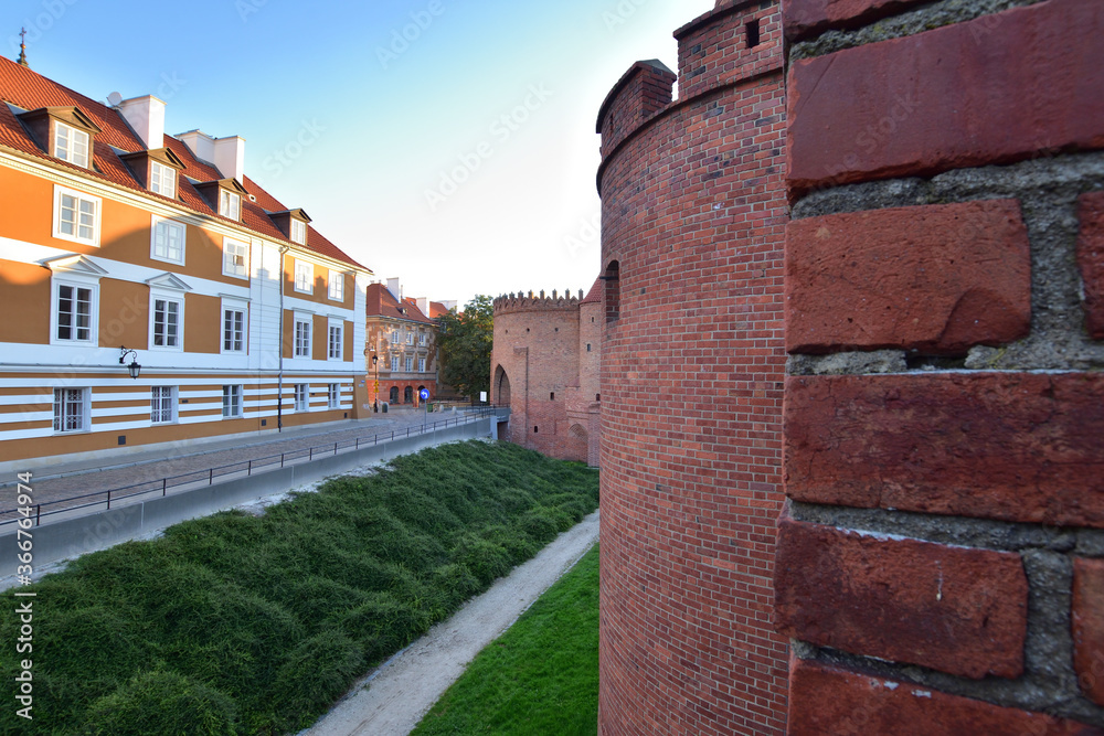 The historic defensive walls of the Warsaw Barbican and burgher houses ...
