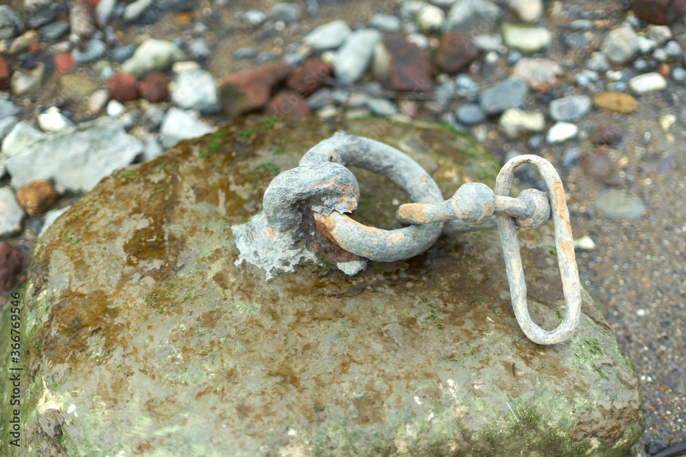 Floating debris and discarded items at the river bank, well washed by ...