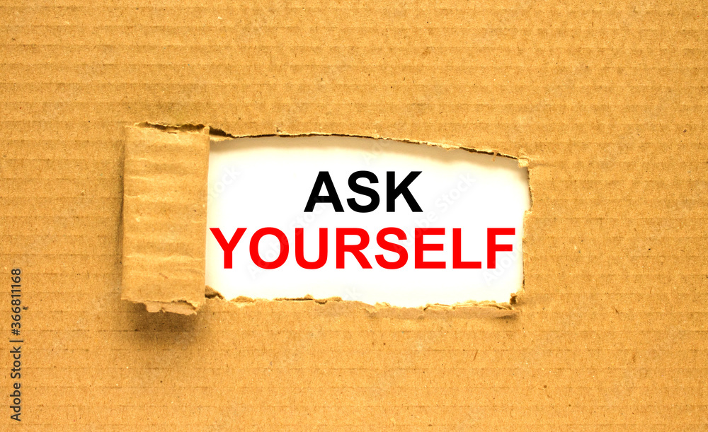 The text Ask Yourself appearing behind torn brown paper Stock Photo ...