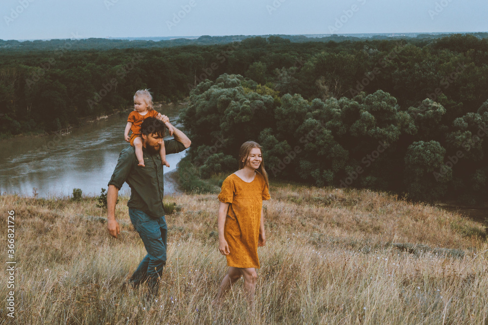 Family parents walking with child outdoor mother and father carrying ...
