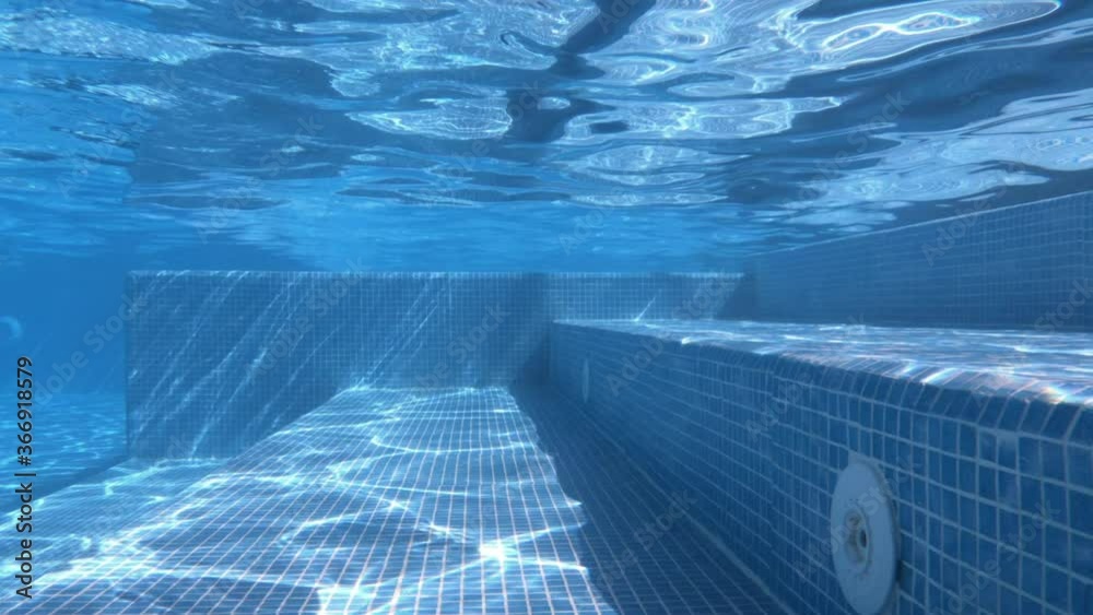 SLOW M - Bottom of the swimming pool. Clear water background with the ...