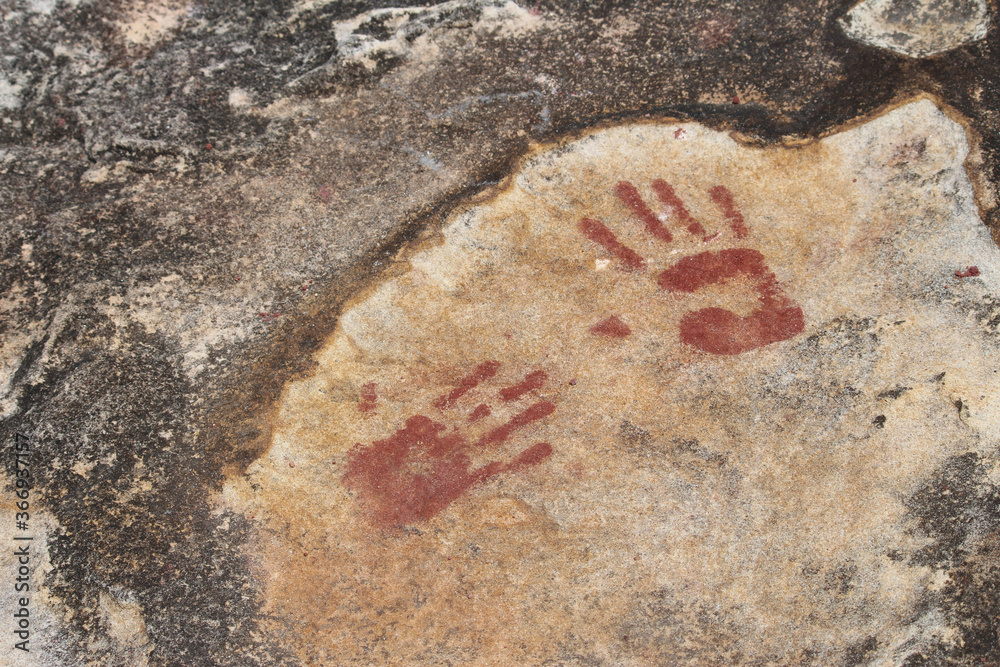 Tribal hand print on sandstone rocks by the ocean. Clovelly Beach ...