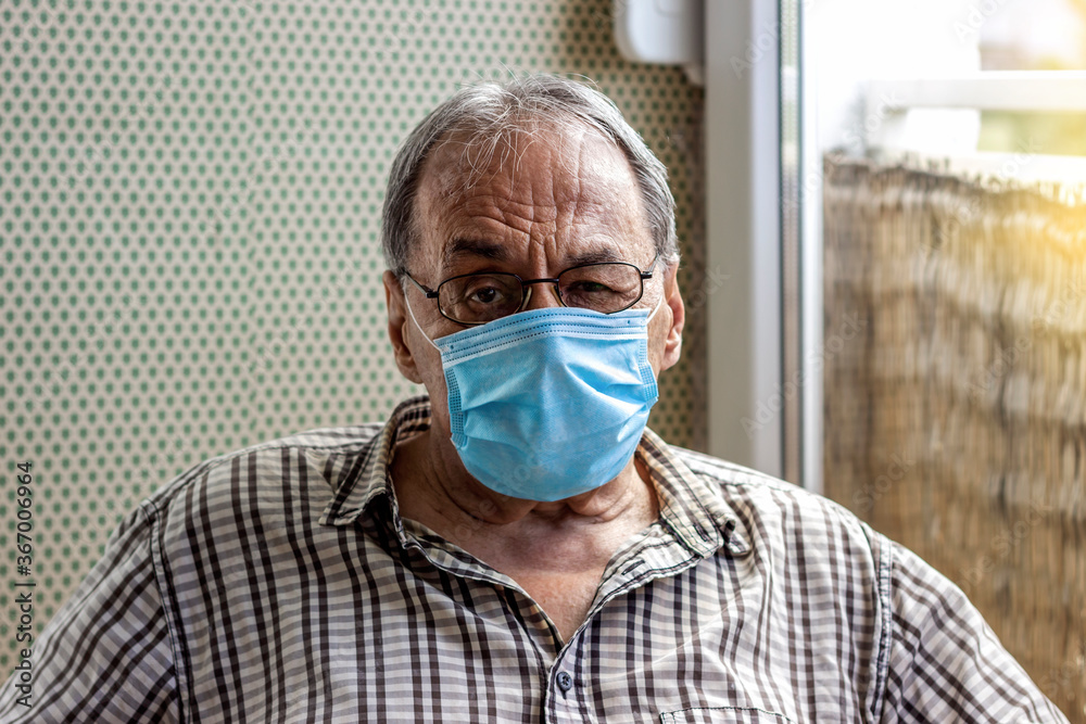 Portrait of a casually dressed youthful senior man at home,wearing an ...