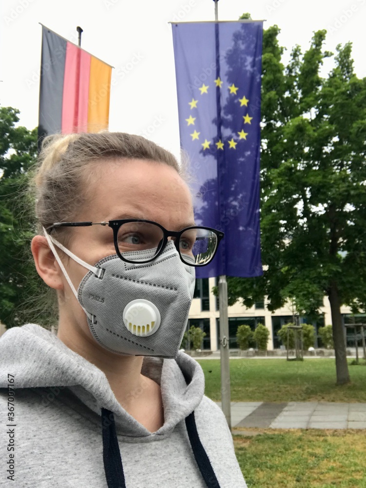 Young blonde caucasian women wearing a professional surgical N95 mask ...