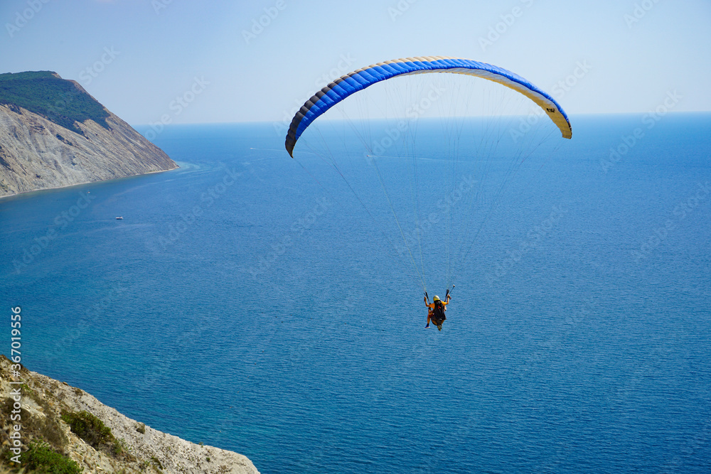Paragliders soar on beautiful paragliders against the background of ...