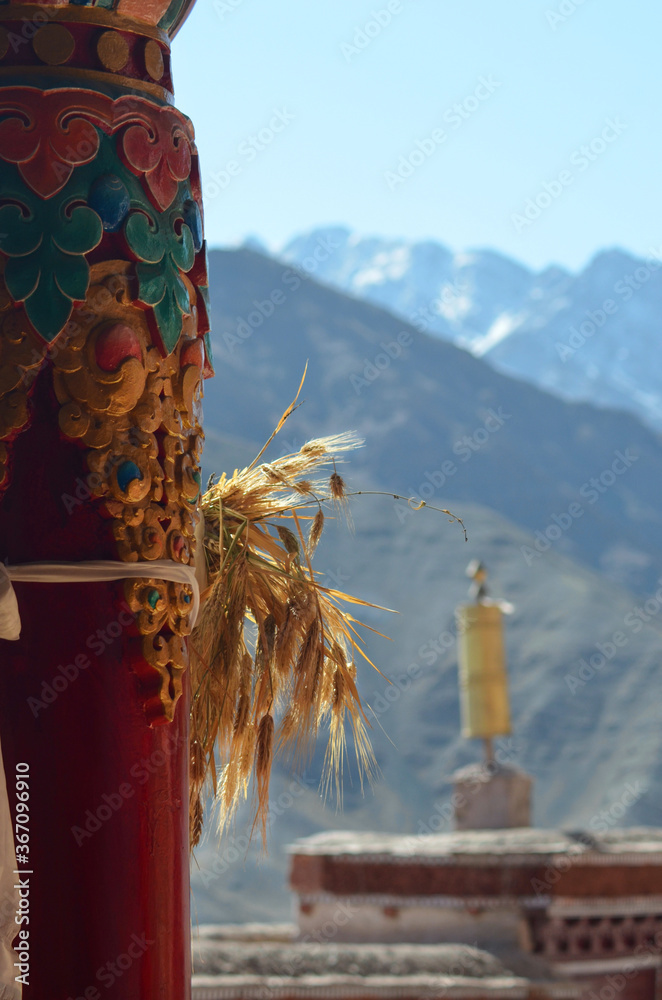 A wooden post painted red and with colourful decorations has dried ...