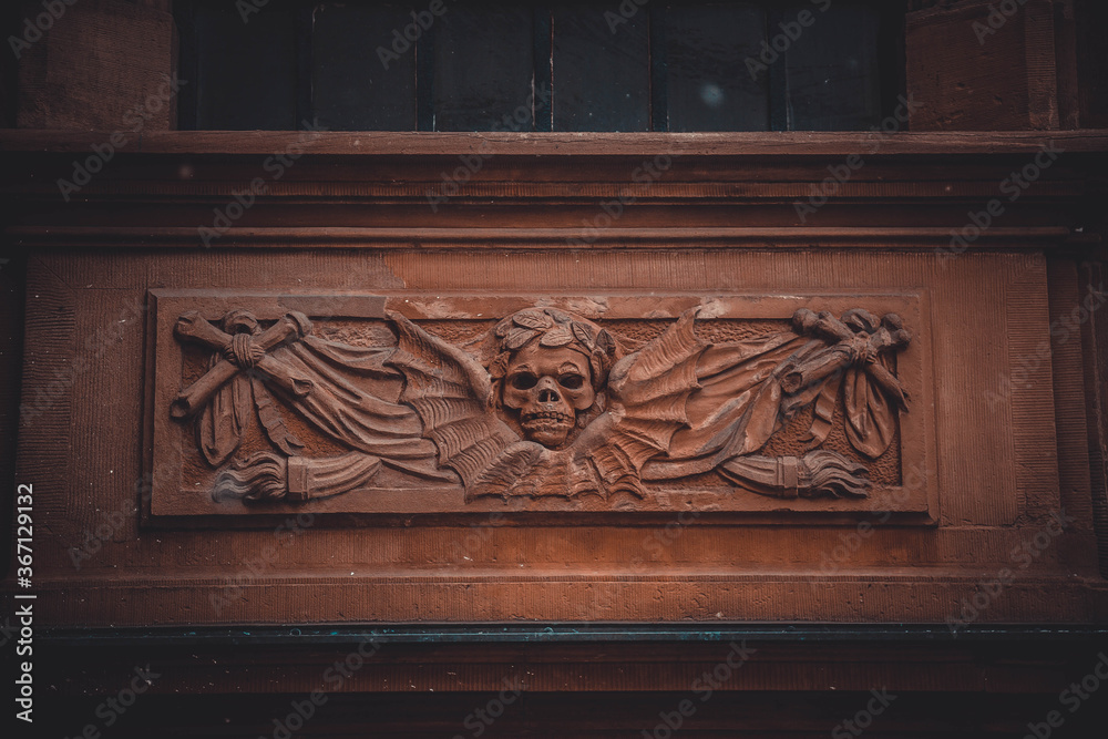 Marble skull and wings on the wall in the Catholic church Stock Photo ...