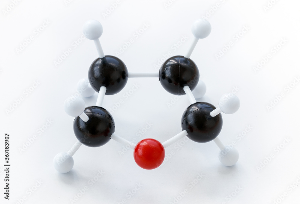 Plastic ball-and-stick model of a tetrahydrofuran (THF) molecule on a ...