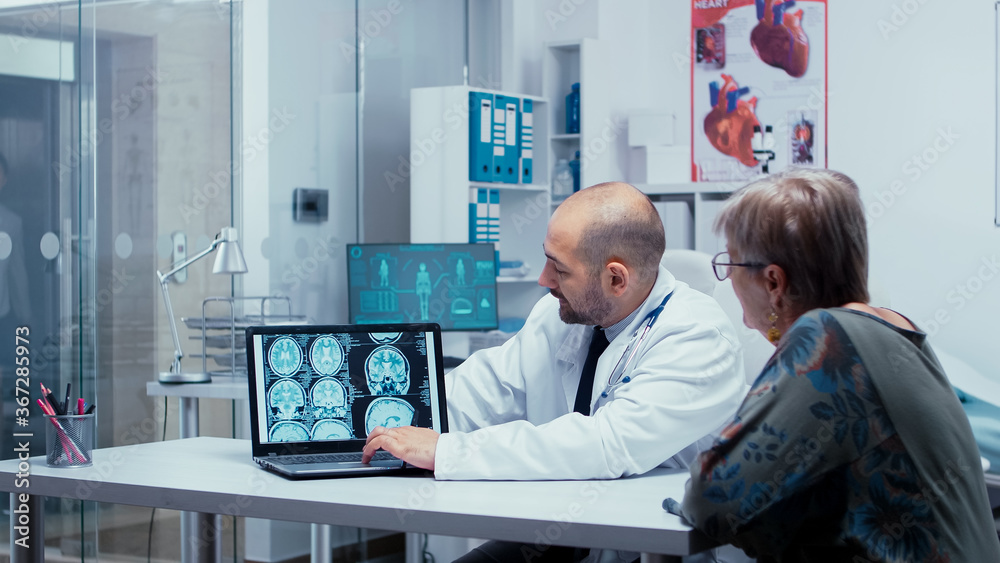 In the doctors office talking about brain scans, CT, MRI and x ray scan ...