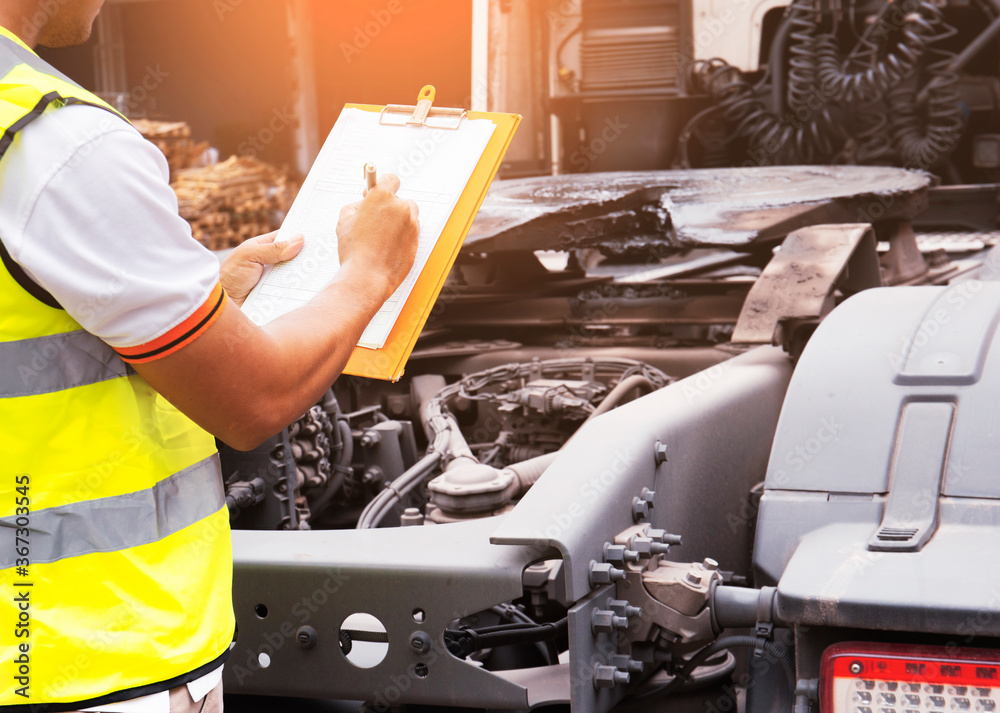 Auto Mechanic is Checking the Semi Truck's Maintenance Checklist ...
