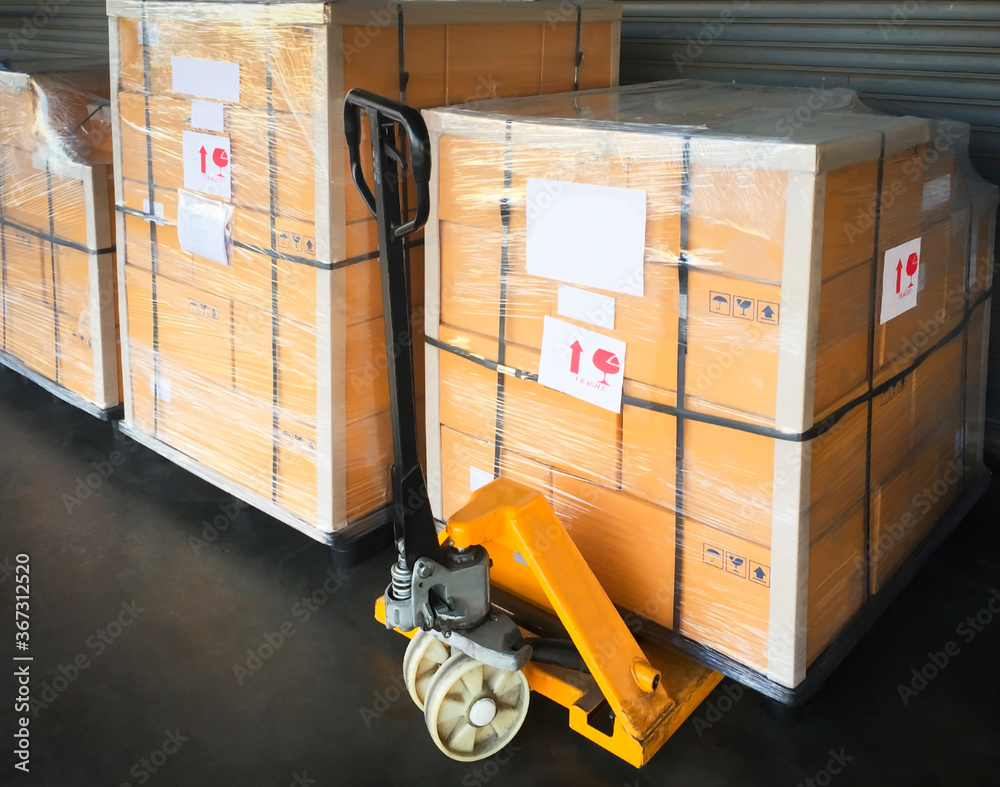 Hand pallet truck with a large shipment pallet goods. Cargo export ...