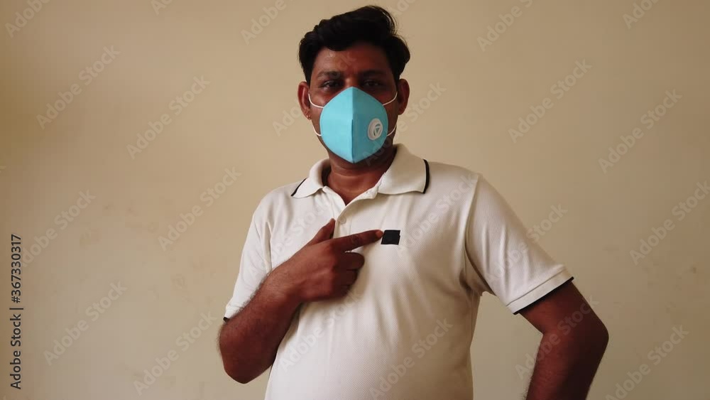 medium mid shot portrait of an asian male wearing a face mask for ...