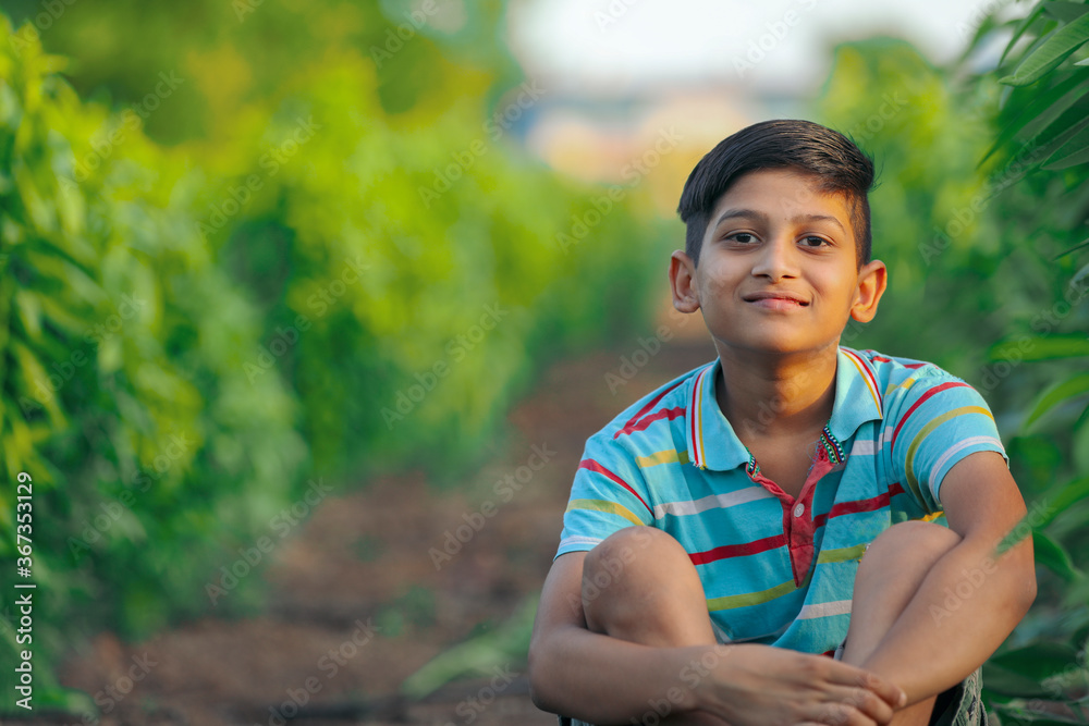 Happy indian child playing at ground Stock Photo | Adobe Stock
