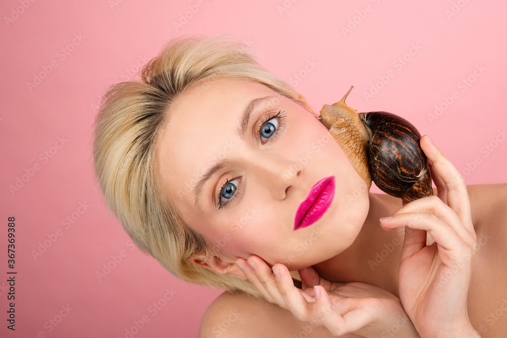 grape snail sitting on girl's face, beautiful and attractive girl with ...