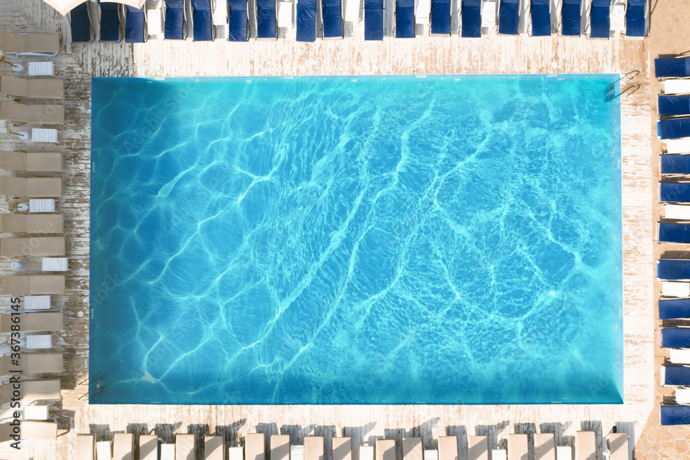 Sun lounge chairs near swimming pool, top view Stock Photo | Adobe Stock