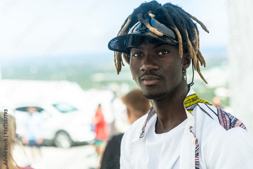 Italian man of Sub-Saharan African descent with sun hat and black and ...