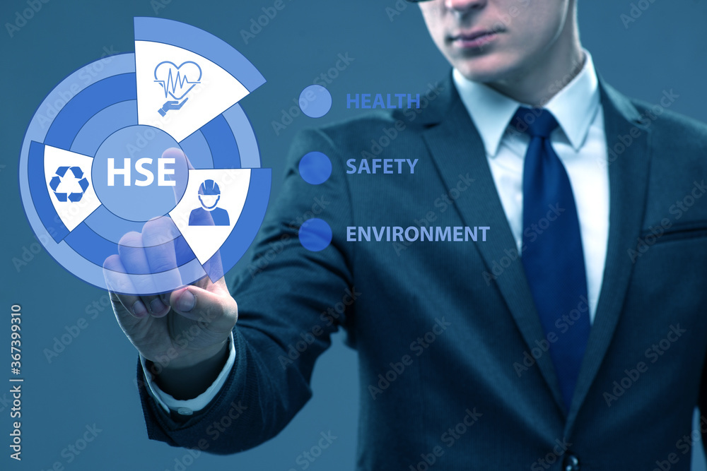 HSE concept with businessman pressing virtual button Stock Photo ...