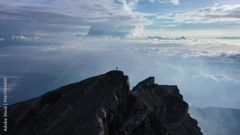 climbing a volcano. Higher than clouds. 4k video. A man walks along the ...