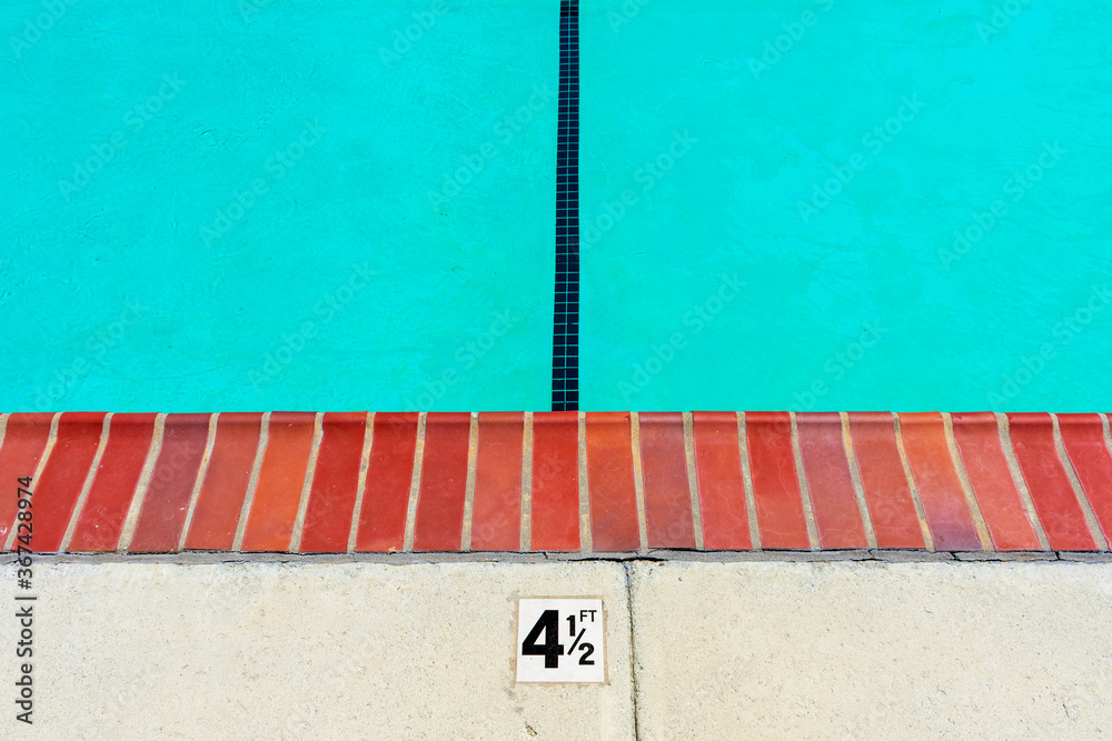 Swimming pool depth marker identifies the water depth for swimmers ...