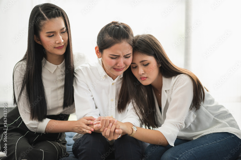 Three women are sad, crying They're comforting their sad friends. They ...
