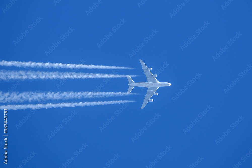 Large four engined commercial airliner jet aircraft flying at high ...