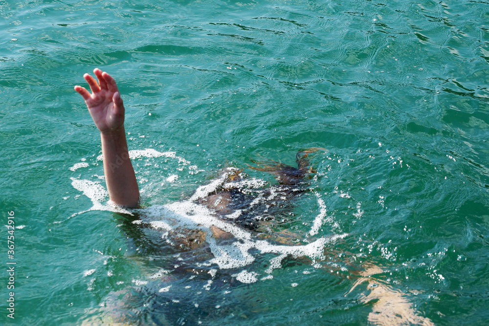 drowning girl raised her hand above the water. Stock Photo | Adobe Stock