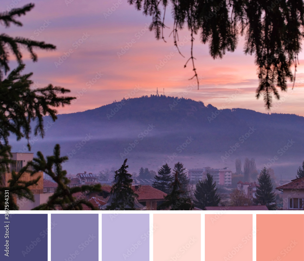 Beautiful colorful sunrise over foggy mountain peak, dramatic violet ...