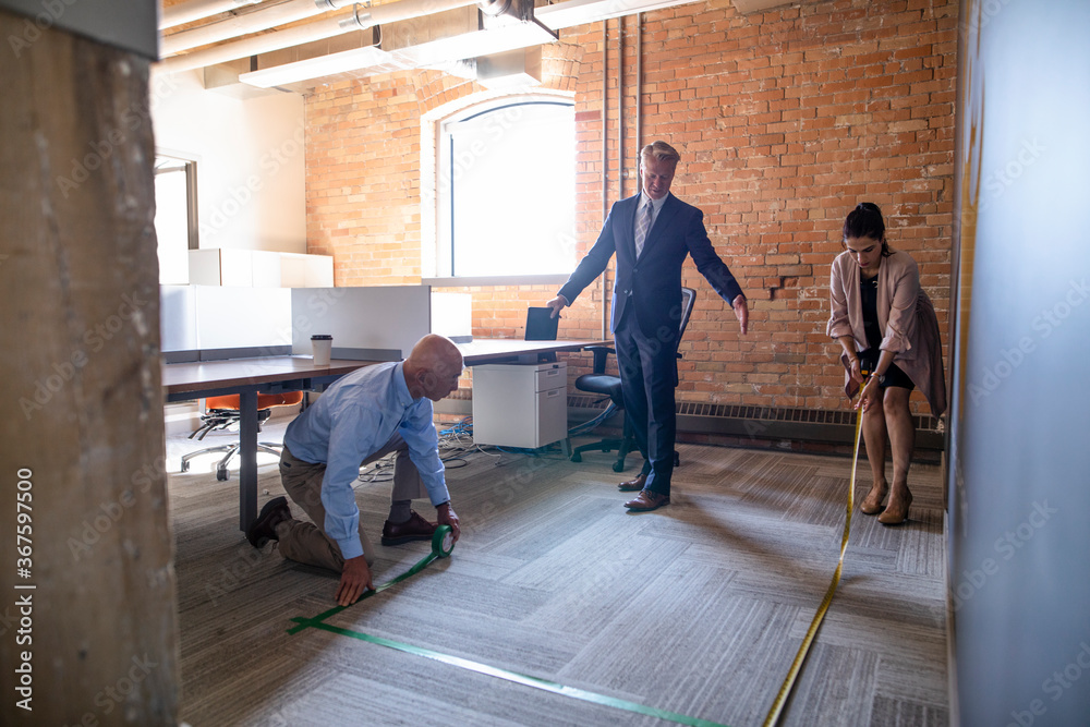 Business people measuring space in new open plan office Stock Photo ...