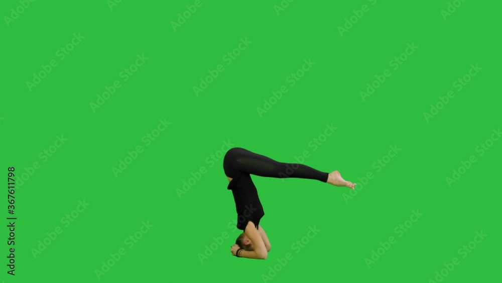 Young woman doing sirsasana yoga pose on a Green Screen, Chroma Key ...