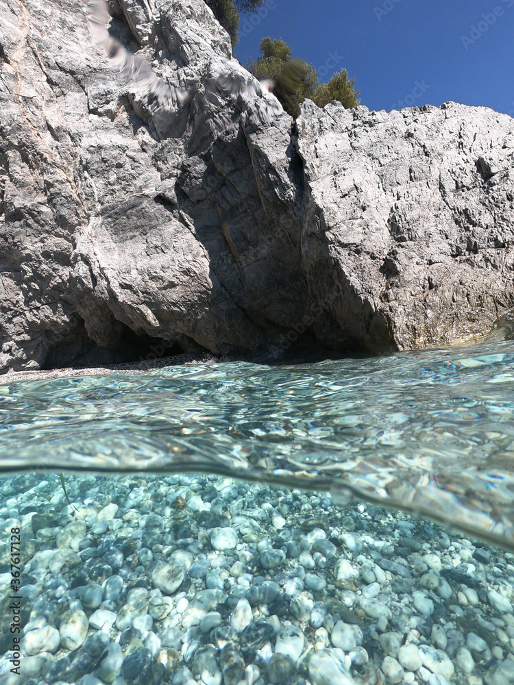 Sea level and underwater photo of caves and rocky nature in famous ...