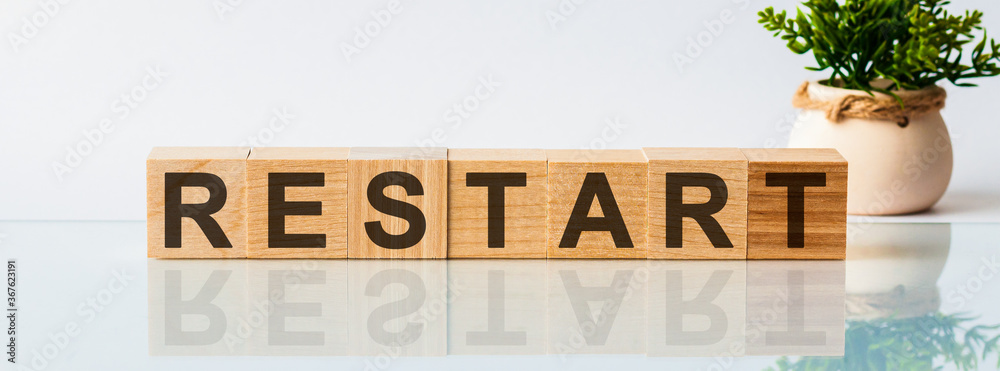 Wooden Blocks with the text: Restart. The text is written in black ...