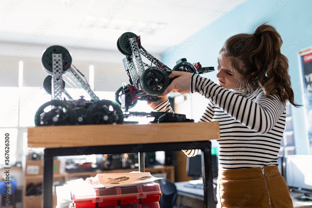 High school girl examining robotics in classroom Stock Photo | Adobe Stock