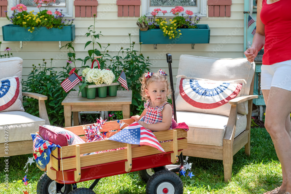 Cute little girl in a red wagon Stock Photo | Adobe Stock