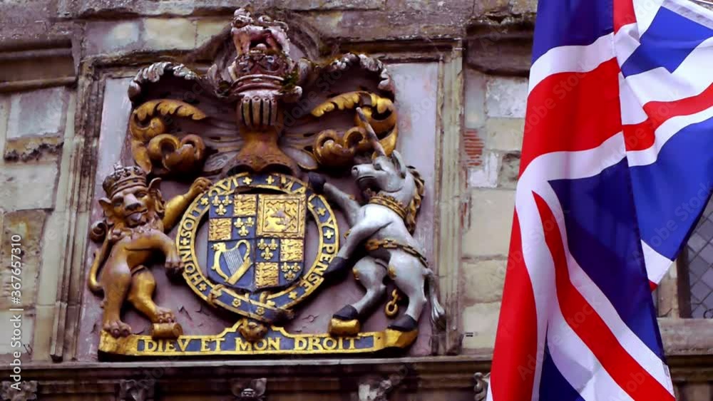 English flag next to an English shield of ancient times on a wall of a ...