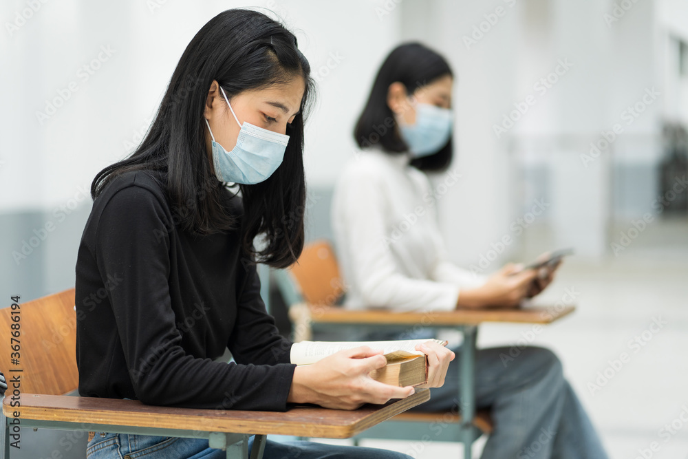 Female teenager college students wears face mask and keep distance ...