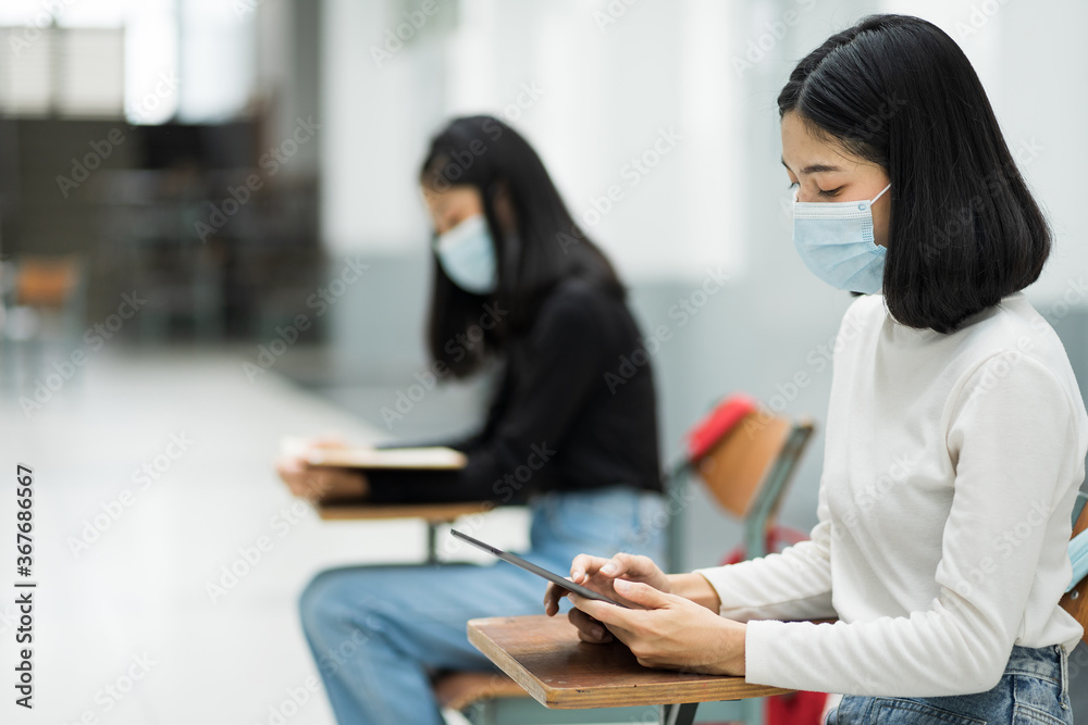 Female teenager college students wears face mask and keep distance ...