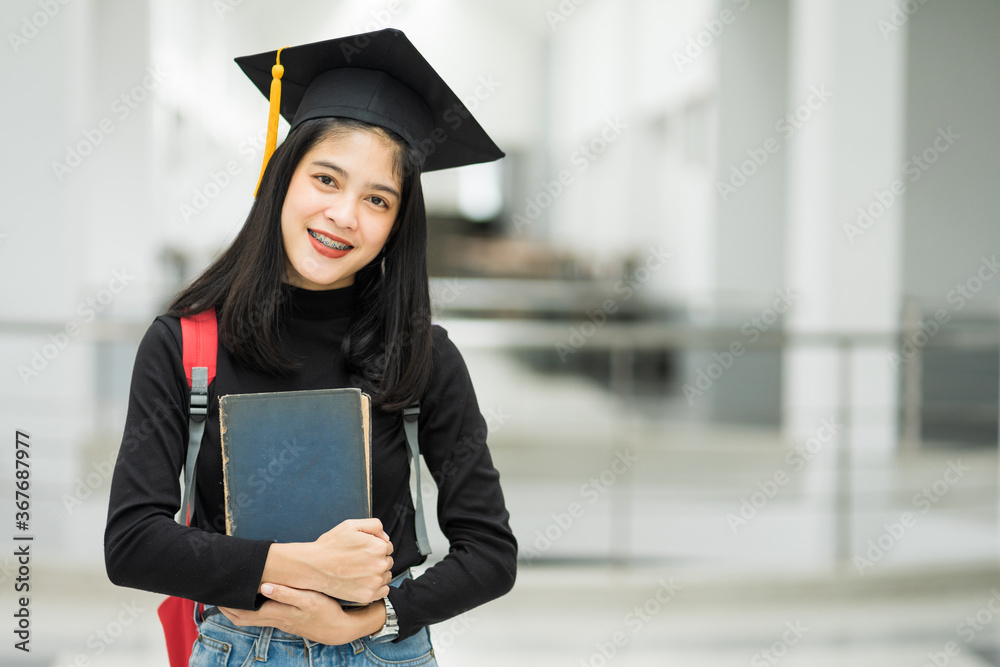 Portrait of female teenager college student holding books with school ...