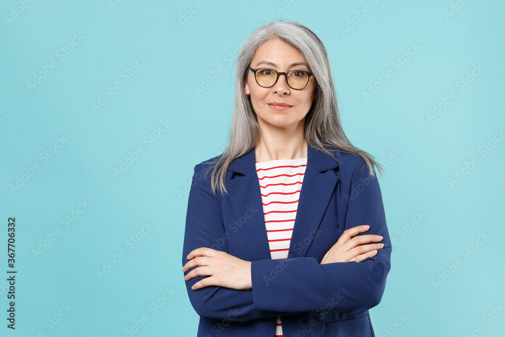 Confident gray-haired business woman in blue suit glasses posing ...