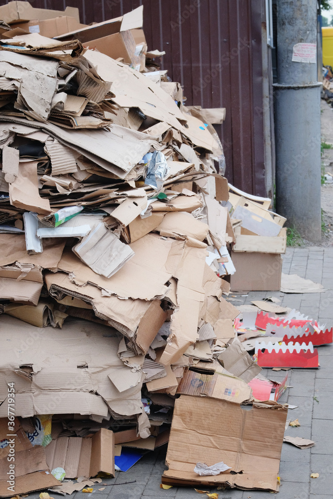 Cardboard and waste paper is collected and packaged for recycling. Pile ...